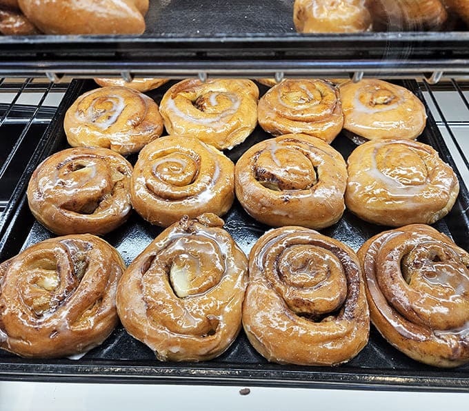 These apple fritter rolls are giving cinnamon roll vibes but with chunks of actual apple, because why choose between breakfast pastries when you can have a hybrid?