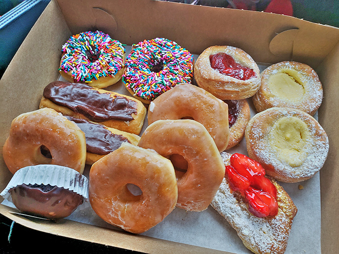 A baker's dozen of joy &ndash; glazed, chocolate-frosted, jelly-filled, and sprinkled donuts nestled together in perfect harmony, waiting to brighten someone's day.