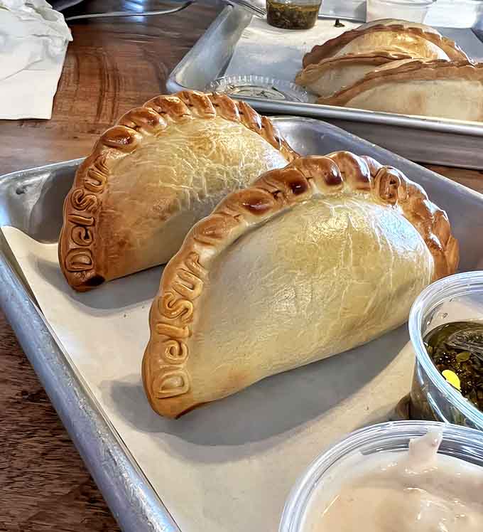 These aren't just empanadas&mdash;they're edible art! Each golden pocket is stamped with DelSur's name, a crispy signature on these hand-folded treasures.