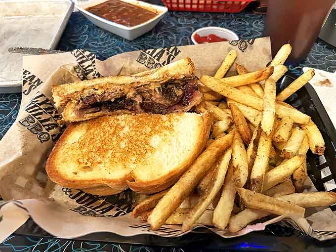 Smoke-kissed brisket nestled between golden bread with crispy fries &ndash; a handheld masterpiece of patience and skill.