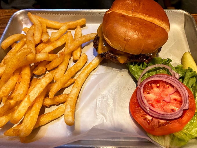 Perfection on a metal tray&mdash;juicy patty, melted cheese, fresh toppings, and a bun that somehow contains the delicious chaos.