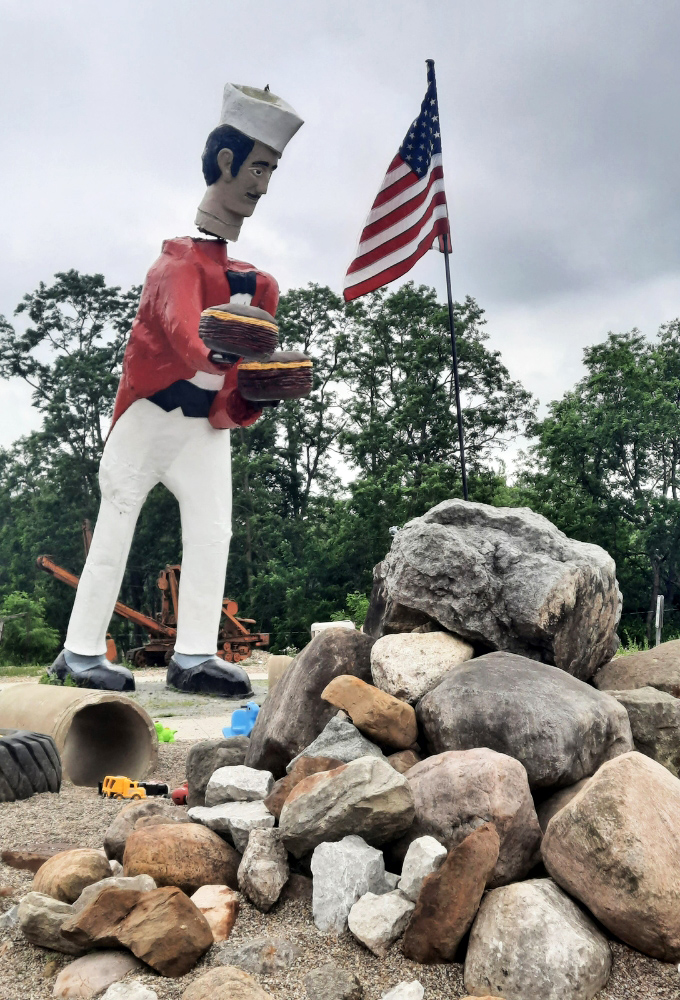 The chef's head may bob, but his commitment to holding those burgers never wavers. Talk about consistent service!