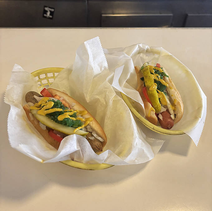 Two perfectly dressed Chicago dogs nestled in paper-lined baskets &ndash; a symphony of toppings arranged with the care of a culinary conductor.