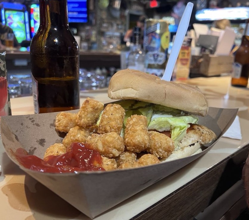 Crispy golden tater tots flank a hearty sandwich &ndash; comfort food that would satisfy even the hungriest recruit after a long march.