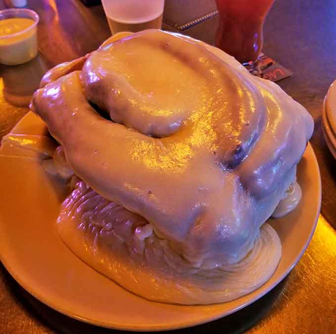 This cinnamon roll isn't just breakfast &ndash; it's a commitment. Drowning in icing and roughly the size of a small throw pillow.
