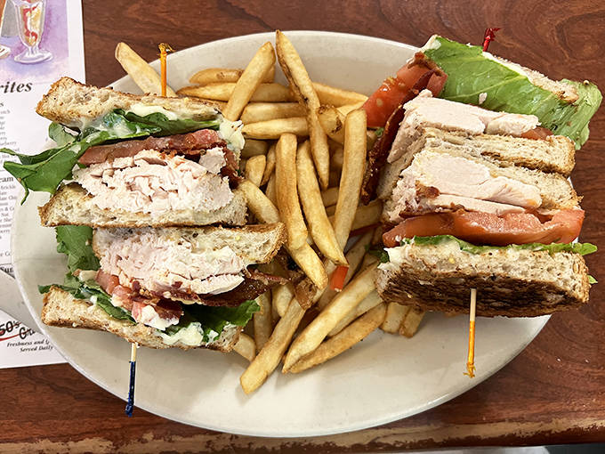 This isn't just a sandwich &ndash; it's architecture on a plate. Layers of turkey, bacon, and fresh veggies create the skyscraper of club sandwiches.