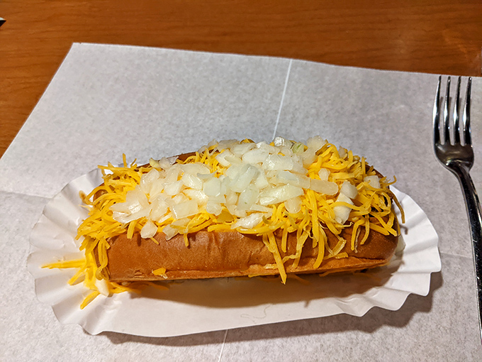 Cheese-covered perfection! These legendary Coneys come loaded with that signature chili, sharp cheddar, and diced onions that'll haunt your food dreams.