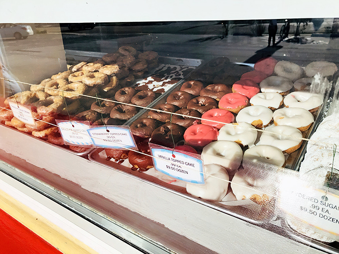 Donut display heaven! Each tray offers a different path to happiness, with glazed, frosted, and filled varieties standing at attention.