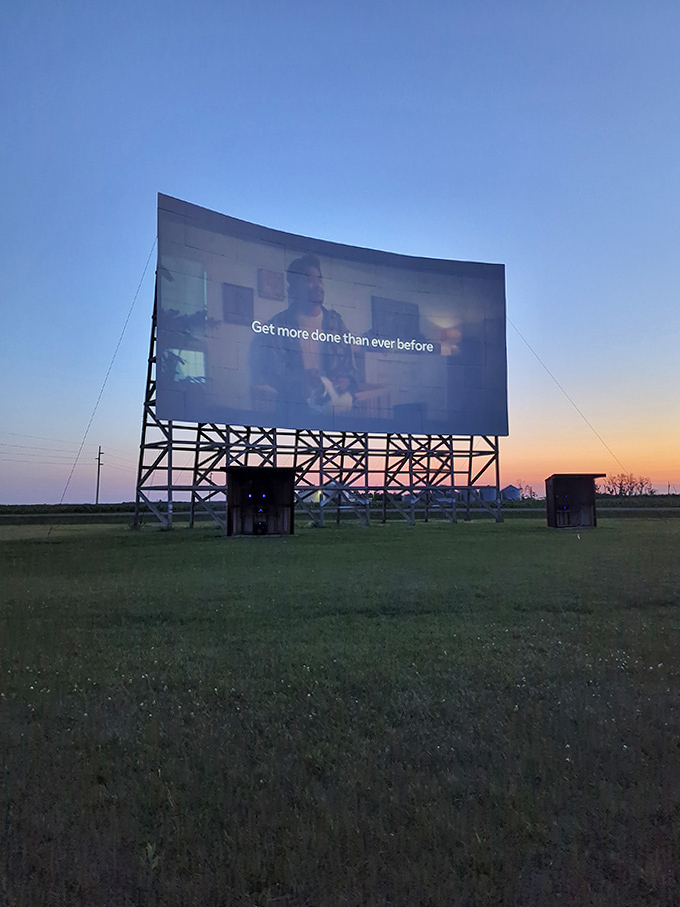 As twilight fades to darkness, the massive screen awakens with light, transforming an ordinary field into cinema magic.