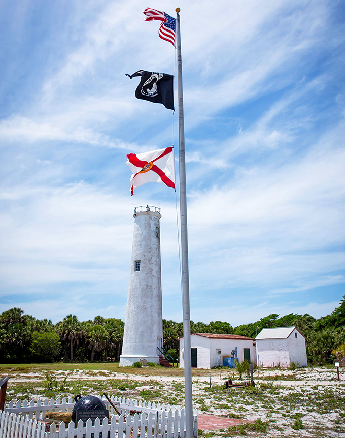 Three flags flutter proudly beside the lighthouse &ndash; symbols of the island's rich military history and continued national significance.