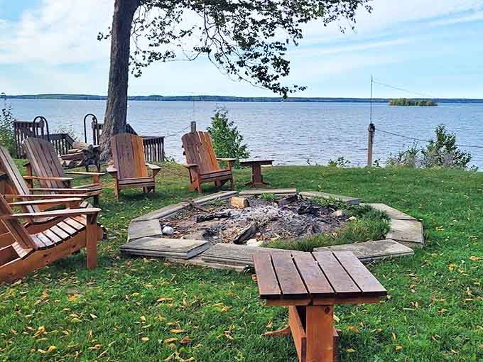 Gather 'round the fire pit where marshmallows meet their delicious destiny and conversation flows as freely as the nearby lake.
