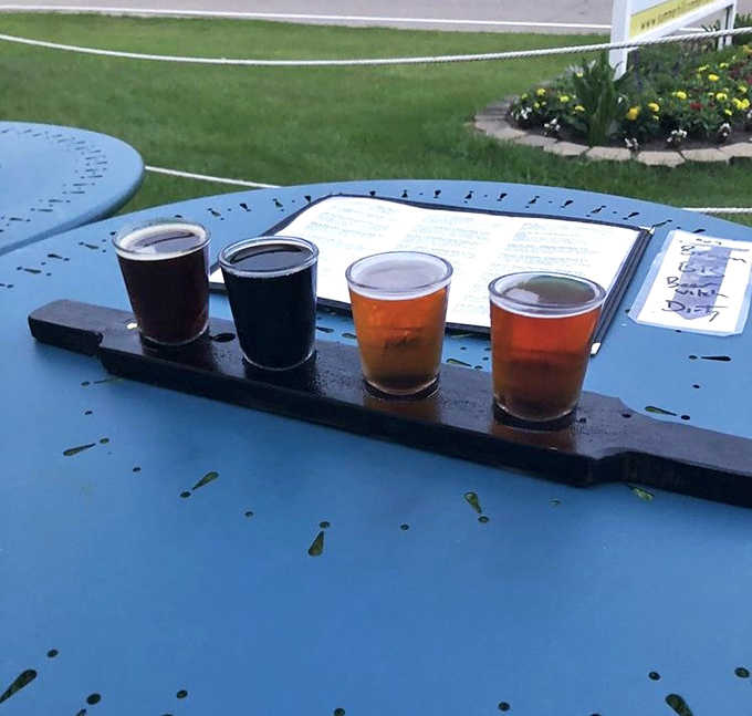 A flight of liquid possibilities awaits on the outdoor patio, where sunshine meets craftsmanship in four perfectly poured tasters.