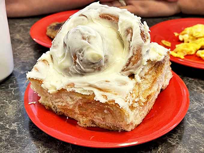 This isn't just any cinnamon roll &ndash; it's a frosted masterpiece of epic proportions that demands a fork, knife, and moment of silent appreciation.