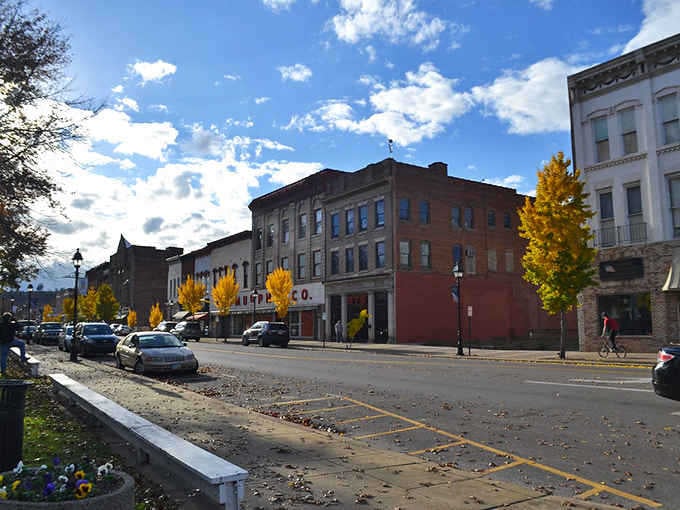 Autumn transforms this riverfront gem into a painter's palette, where brick buildings pop against nature's seasonal fashion show.