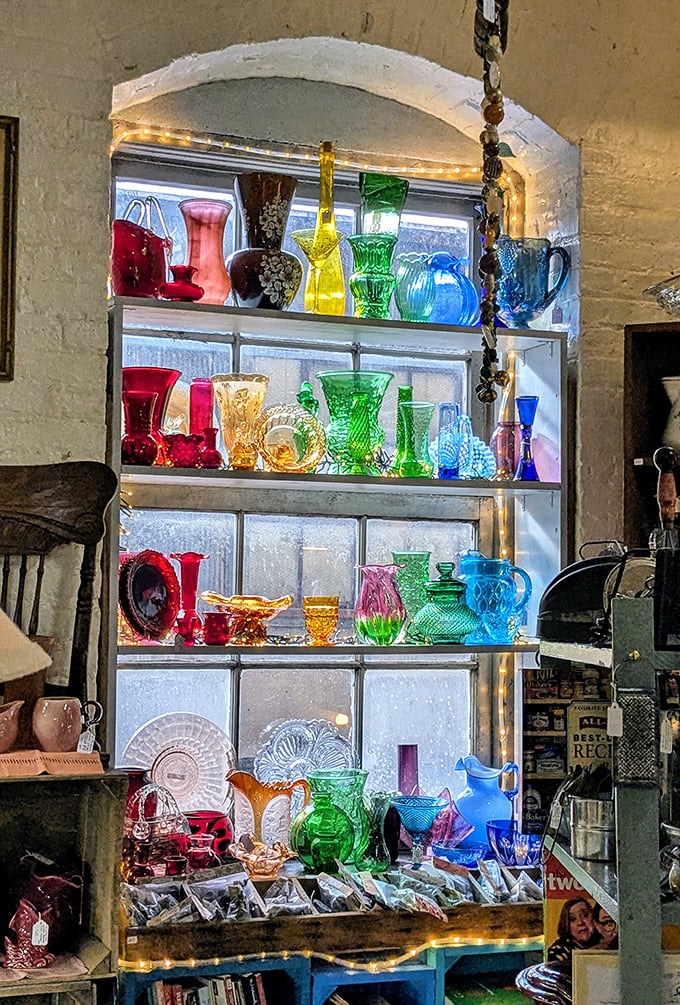 A rainbow of vintage glassware catches the light like jewels in a treasure chest &ndash; each colorful piece tells stories of elegant dinner parties and special occasions past.