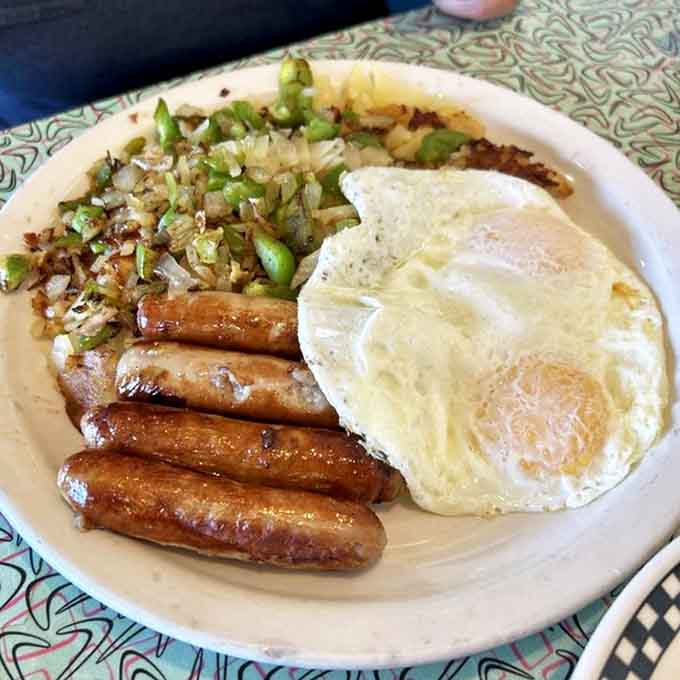 Grand Diner Special: Breakfast perfection on a plate &ndash; golden sausage links, farm-fresh eggs, and hash browns studded with peppers and onions that sing with flavor.