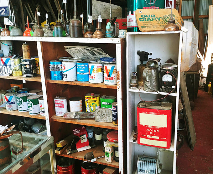 Vintage oil cans and advertising memorabilia create a colorful timeline of American consumer culture.