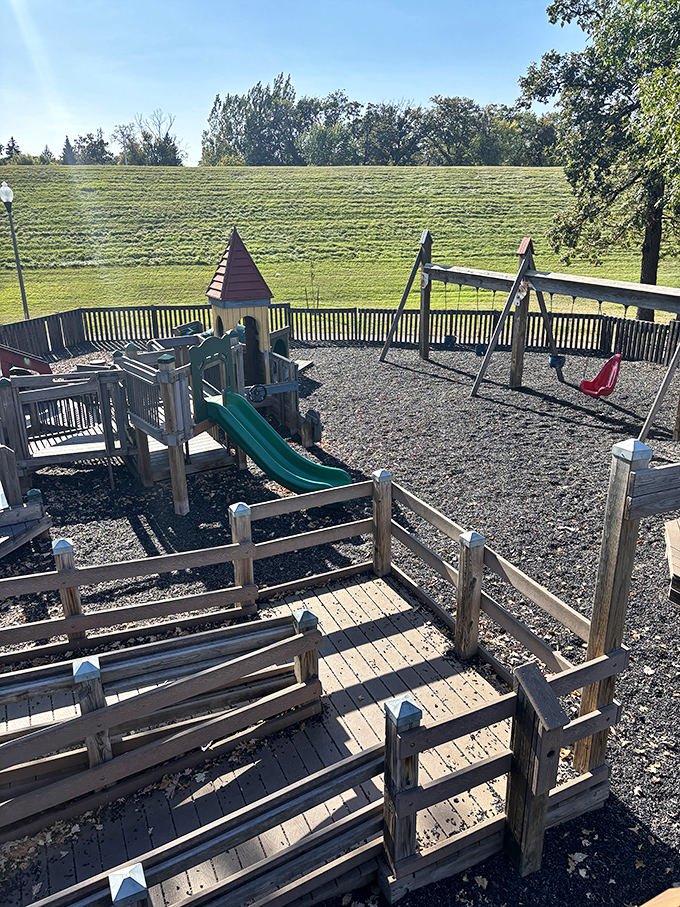 Simple wooden slides and swings prove that sometimes the most basic playground elements deliver the purest childhood joy.