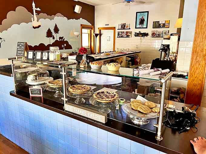 A glass showcase of handcrafted pies stands ready to fulfill your sweetest dreams, each one a testament to butter, patience, and skill.