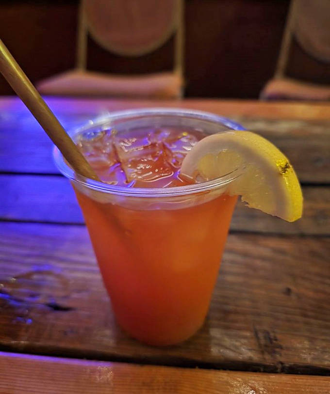 The Island Punch glows amber in the afternoon light, its dark rum floater creating a sunset effect in your glass.