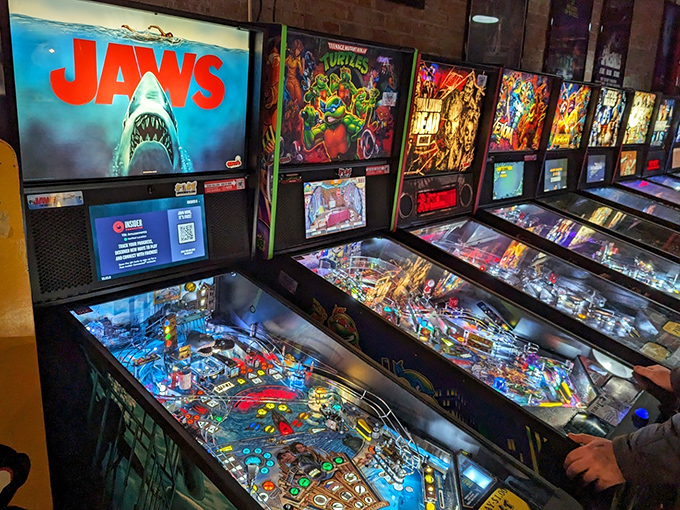 The JAWS pinball machine lurks among other favorites, ready to swallow quarters and challenge even the steadiest flipper hands.