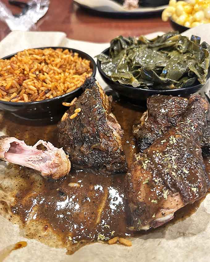 Jerk chicken so tender it falls off the bone, accompanied by perfectly seasoned rice and collard greens that soak up every bit of flavor.