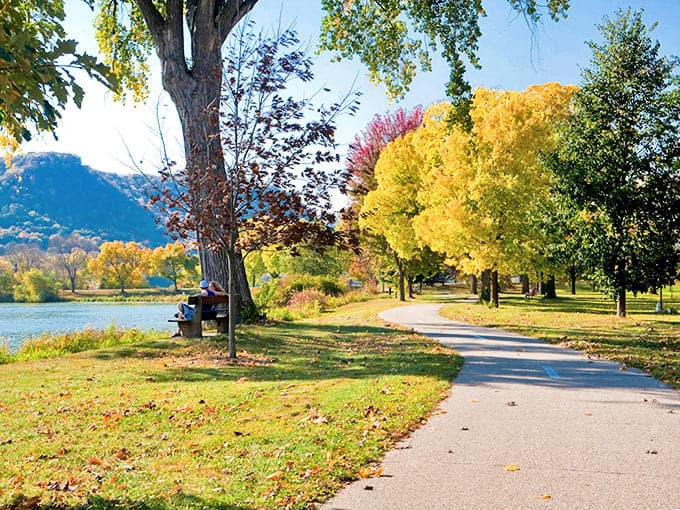 Lake Winona's shoreline path invites autumn strollers to lose themselves in a symphony of gold and crimson reflections.