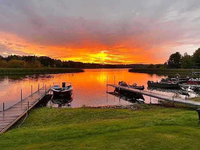 Boats rest peacefully as the setting sun transforms an ordinary Minnesota lake into a masterpiece of light and reflection.