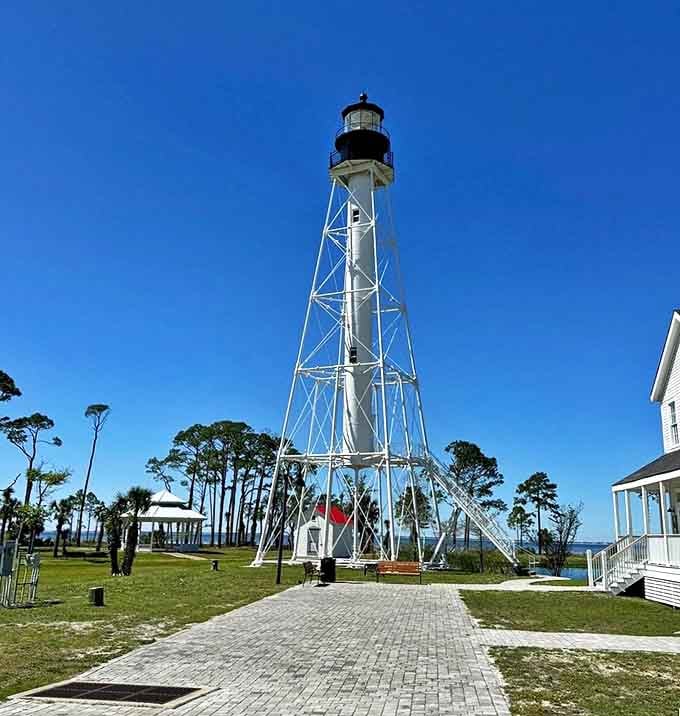 The lighthouse stands tall with the kind of architectural confidence that comes from surviving multiple relocations and still looking fabulous.