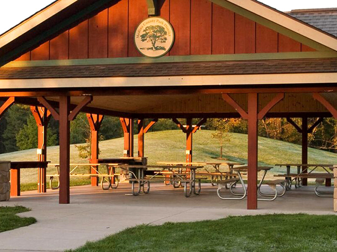 This rustic pavilion in Medina County Park District offers a peaceful retreat where picnic tables await families and the occasional squirrel looking for leftovers.