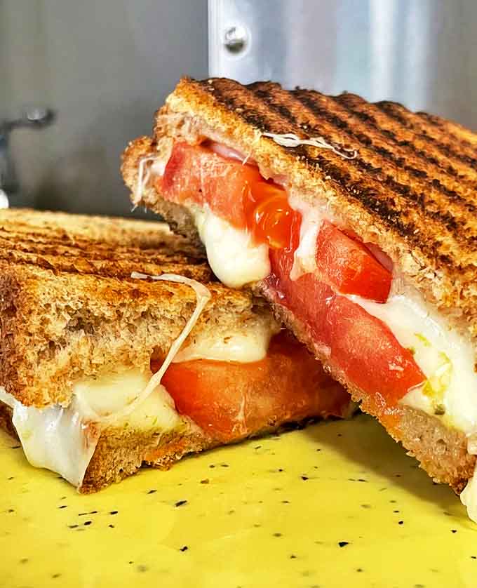 This breakfast sandwich brings the heat with perfectly grilled bread hugging melted cheese and fresh tomatoes in glorious harmony.