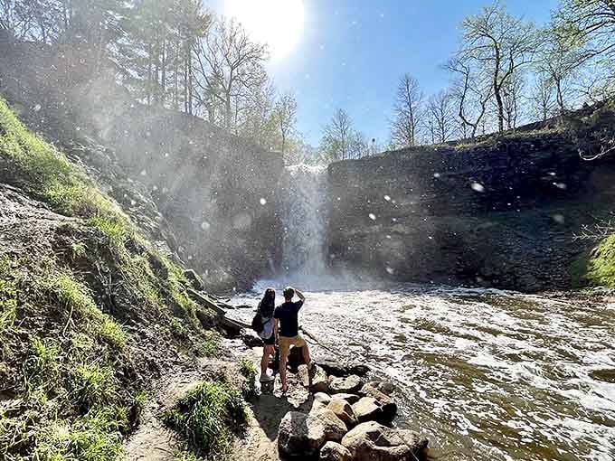 Visitors brave the mist for that perfect waterfall selfie – worth getting a little damp for memories this spectacular!