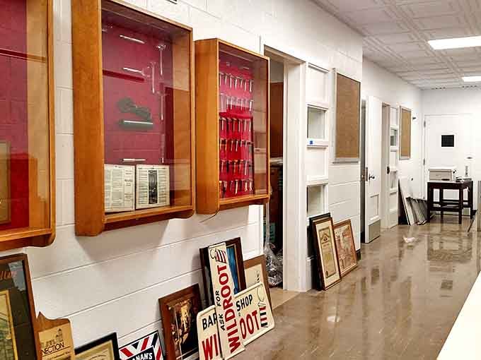 Display cases filled with the tools of the trade line the hallway, showcasing everything from straight razors to hair tonics.