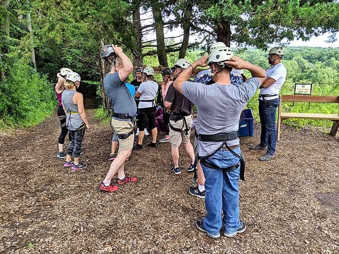 Safety first! These adventurers listen intently during their pre-flight briefing, unaware they'll soon be transformed into treetop daredevils.