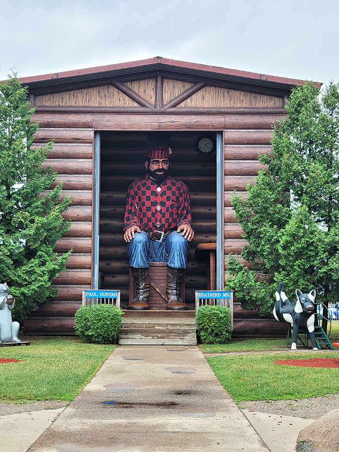 The iconic lumberjack sits in his custom-built cabin, ready to surprise visitors by greeting them by name as they approach.