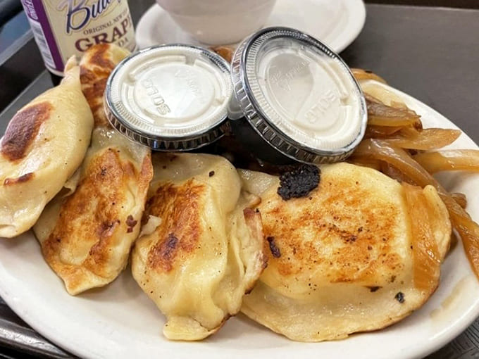 Golden-brown pierogis glisten with butter, their perfectly crimped edges holding treasures of potato, cheese, and tradition within.