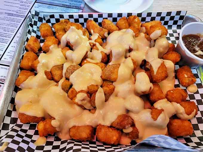 Golden cheese curds cascade over crispy fries in this poutine masterpiece &ndash; comfort food worthy of its own standing ovation.