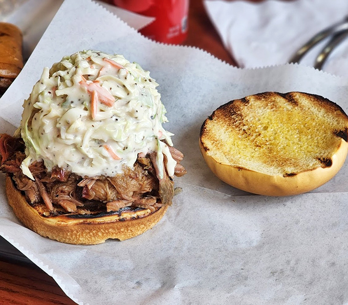 This pulled pork sandwich isn't just a meal, it's an event &ndash; tender smoked meat crowned with creamy coleslaw on a perfectly toasted bun.