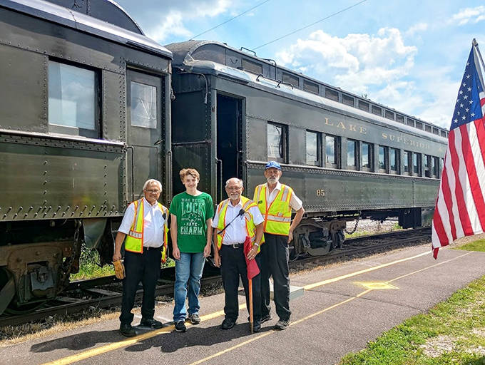 Dedicated volunteers in safety vests share their railroad passion, creating connections between Minnesota's transportation history and today's visitors.