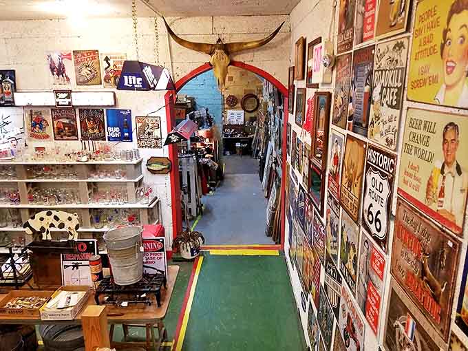 A nostalgic corridor lined with vintage signs and memorabilia—where Route 66 meets your childhood memories under longhorn supervision.