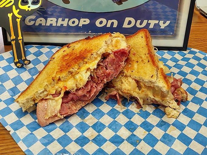 The classic Reuben reveals its secrets: perfectly grilled rye bread giving way to layers of tender corned beef and tangy sauerkraut in perfect harmony.