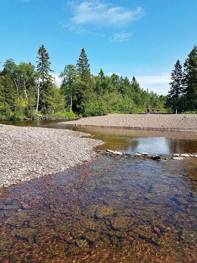 The Gratiot River meanders peacefully through the wilderness before meeting Lake Superior, creating a perfect spot for contemplation or fishing.