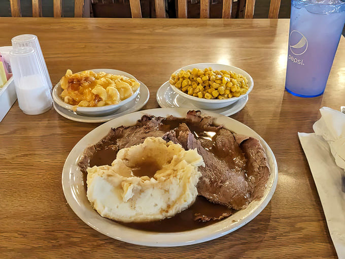 Tender slices of roast beef swimming in rich gravy, paired with fluffy mashed potatoes and golden corn &ndash; comfort on a plate.