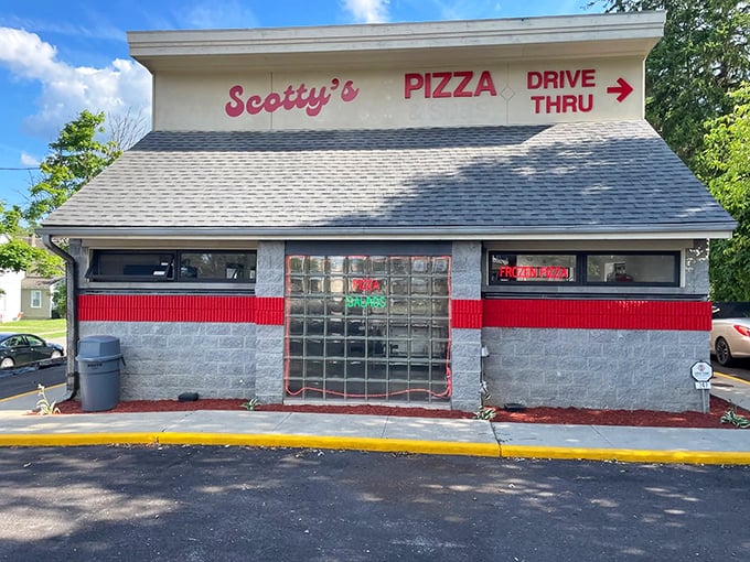 Scotty's Pizza combines nostalgic charm with practical convenience, its red-trimmed drive-thru window serving as a portal to pizza happiness.