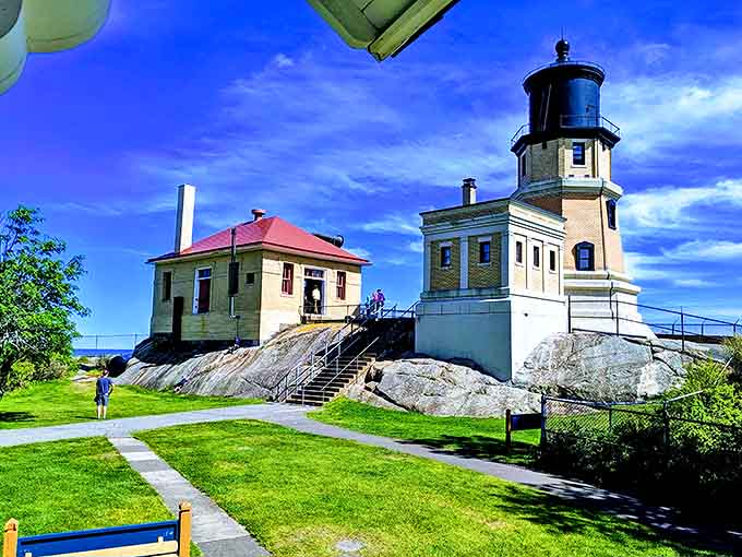 The lighthouse and keeper's quarters stand sentinel against time and weather, a yellow-brick reminder of human ingenuity against nature's might.