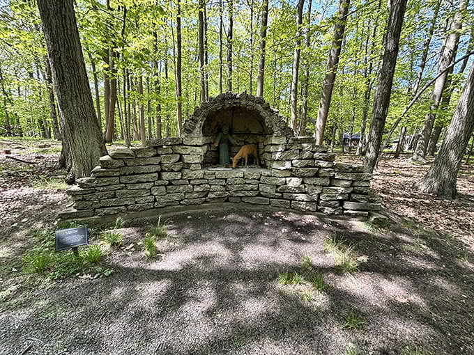 This rustic stone grotto dedicated to St. Francis creates a peaceful alcove where visitors can pause for a moment of woodland reflection.