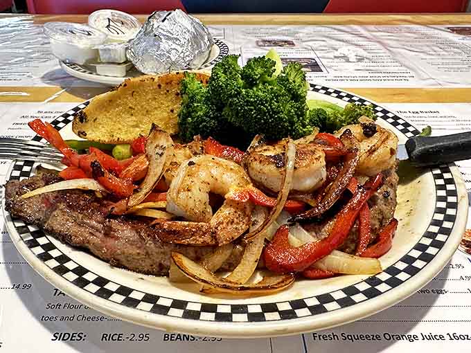 This surf-and-turf plate pairs a perfectly seared steak with succulent shrimp, proving comfort food can still surprise the taste buds.