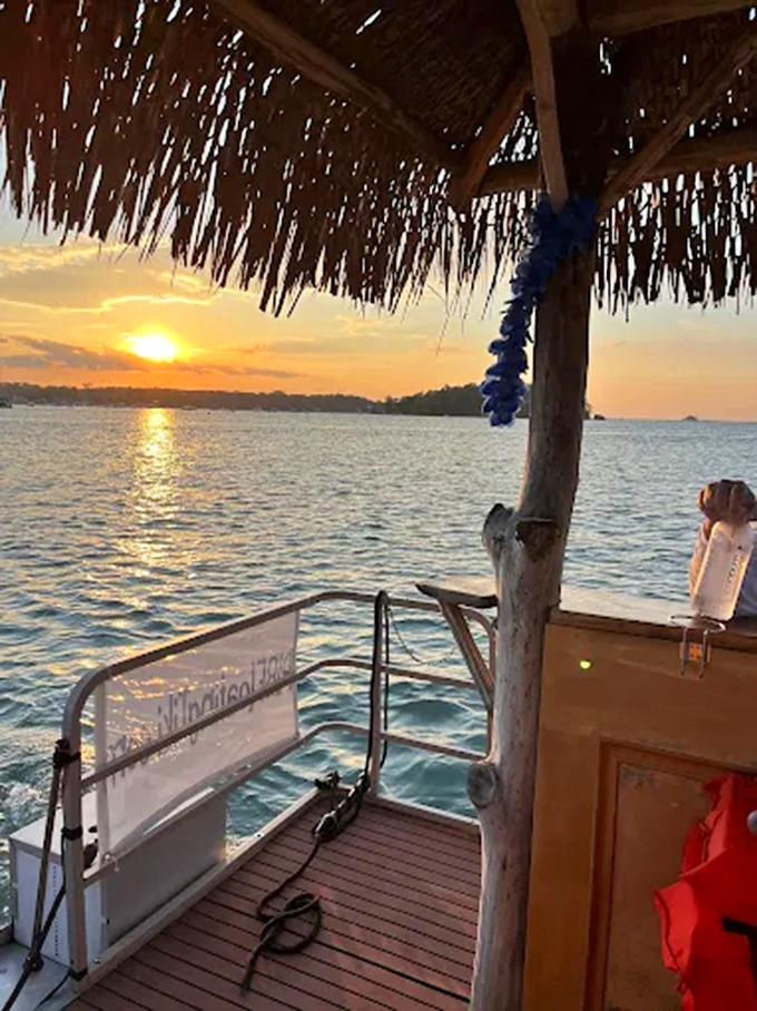 Sunset magic filters through the thatched roof, creating the perfect golden-hour ambiance for sipping your favorite island beverage.
