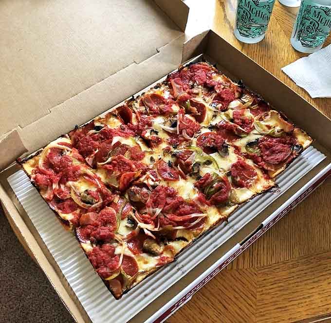 This loaded supreme pizza isn't just food&mdash;it's architecture, with layers of toppings supported by that legendary airy-yet-crispy Detroit-style crust.