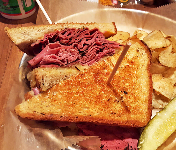 This isn't just a Reuben; it's a towering monument to the art of sandwich-making that demands both hands and your full attention.